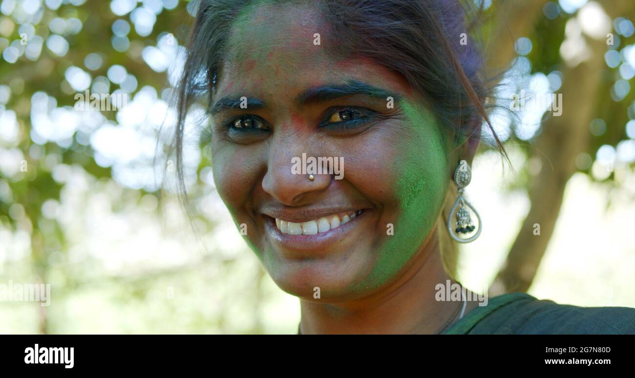 Closeup shot of an Indian woman with a coloured face on the festival of ...