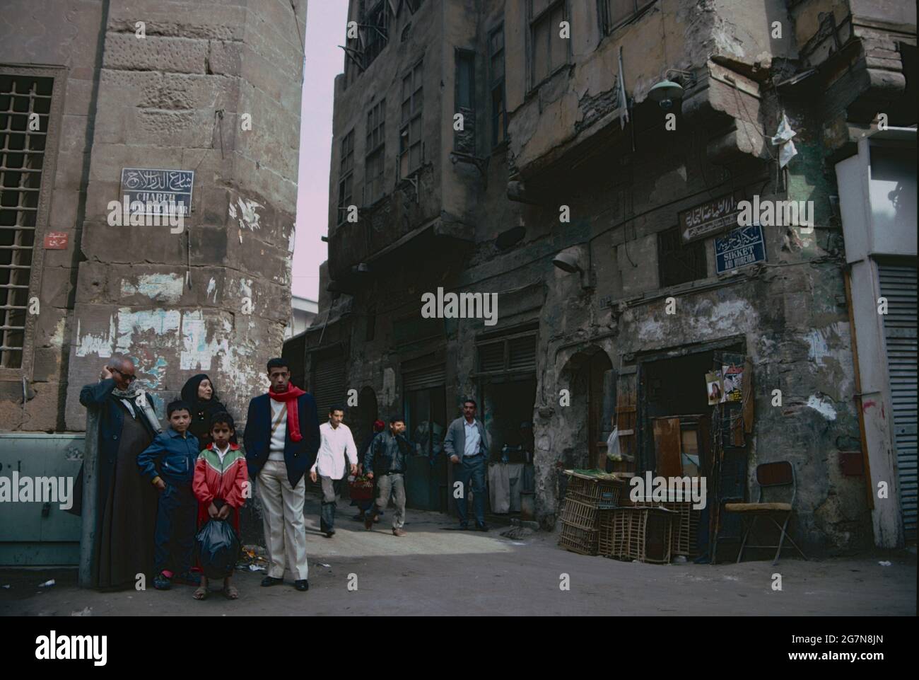 Egyptian family wait on a street corner in the Al-Darb al-Ahmar ...
