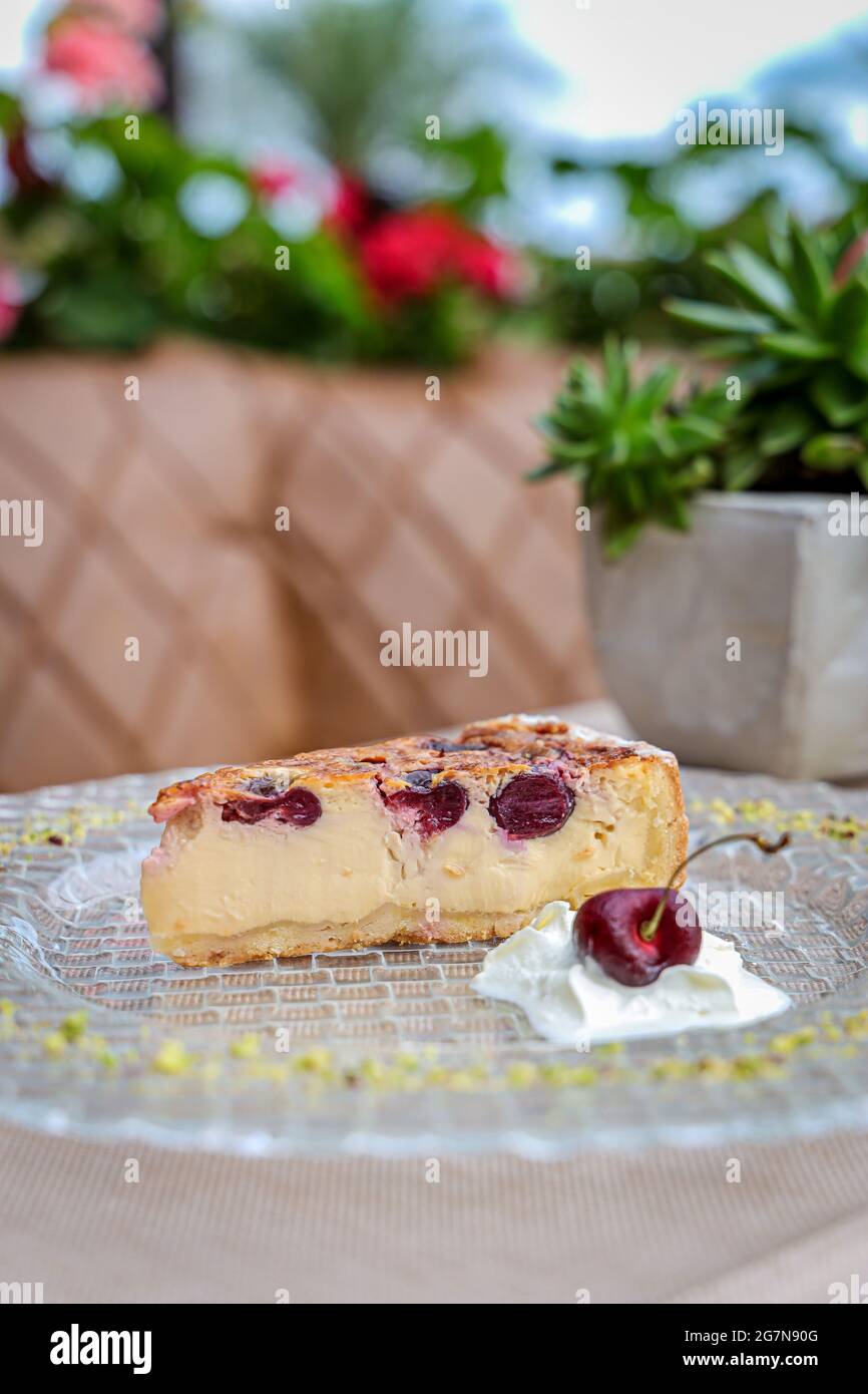 Vertical shot of a pie with cherry on the plate Stock Photo - Alamy