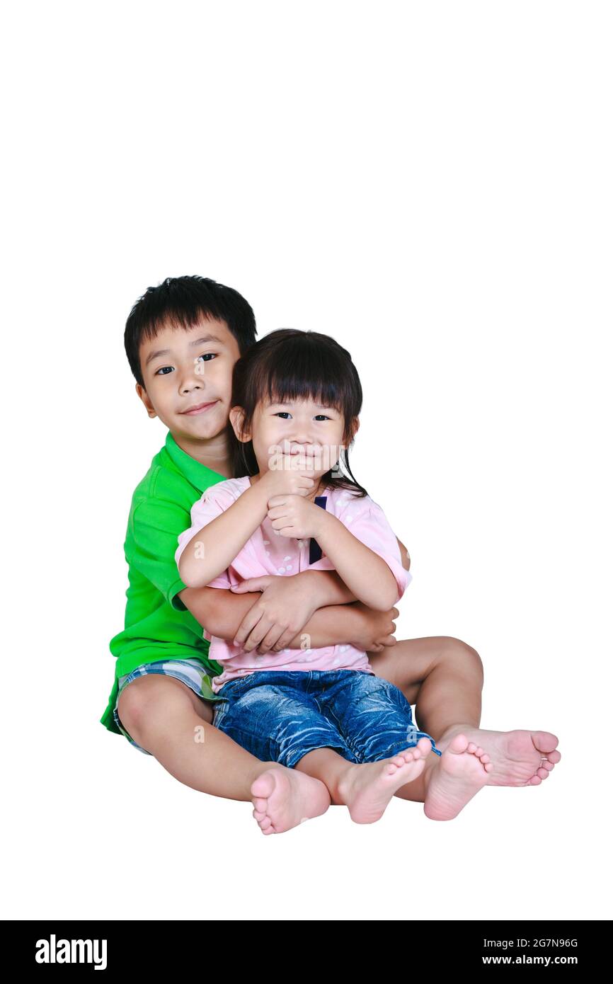 Asian kindly brother hugging his sister smiling happy together ...