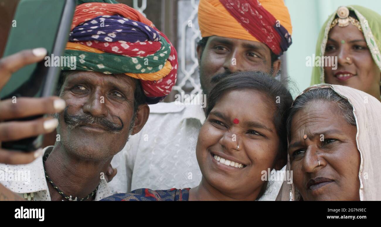 Group of South Asian people in traditional Indian clothing taking a ...