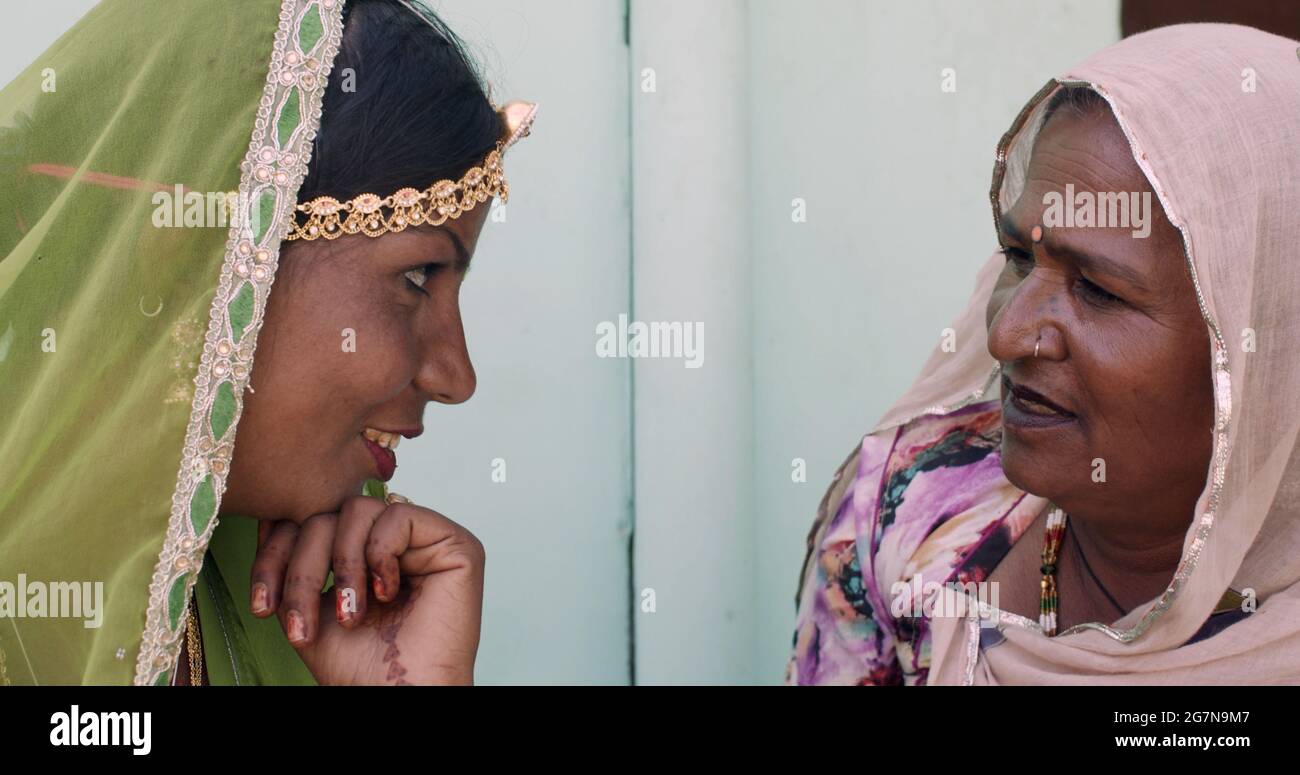 Two indian woman having a conversation outdoors Stock Photo - Alamy