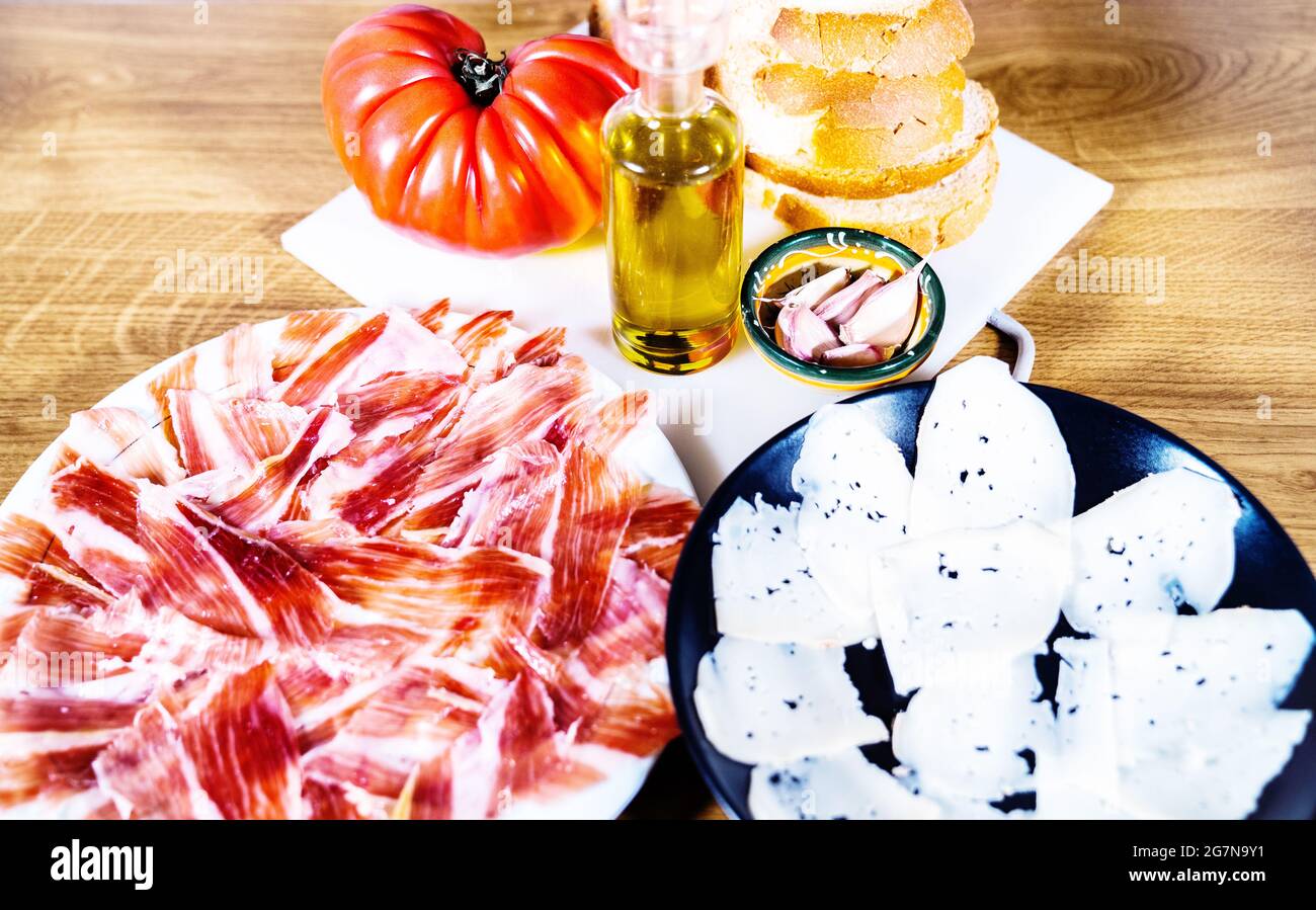 Typical Catalan or Spanish food. Bread with tomato, Iberian ham plate ...