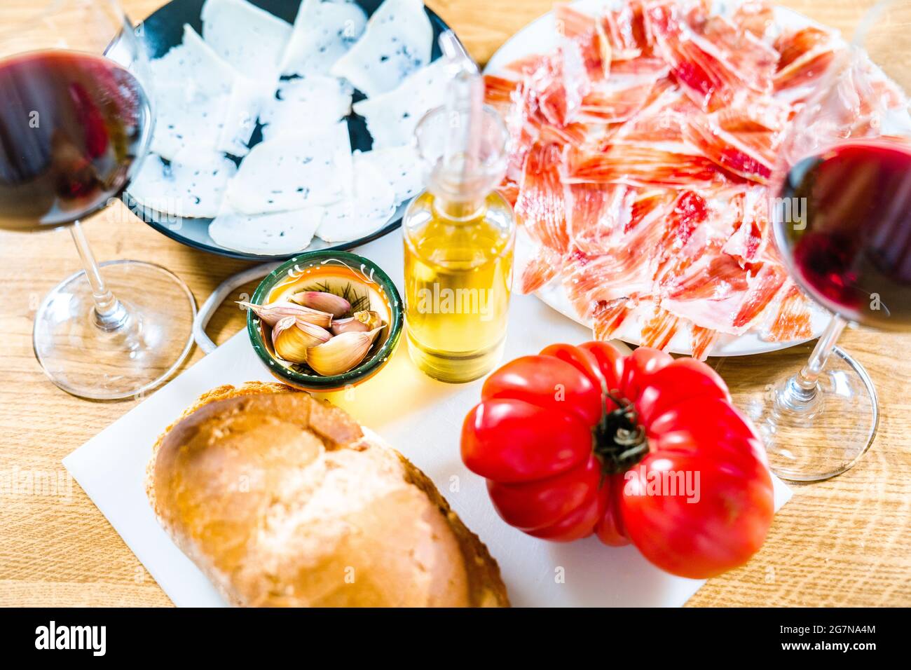 Typical Catalan or Spanish food. Bread with tomato, Iberian ham, glass ...