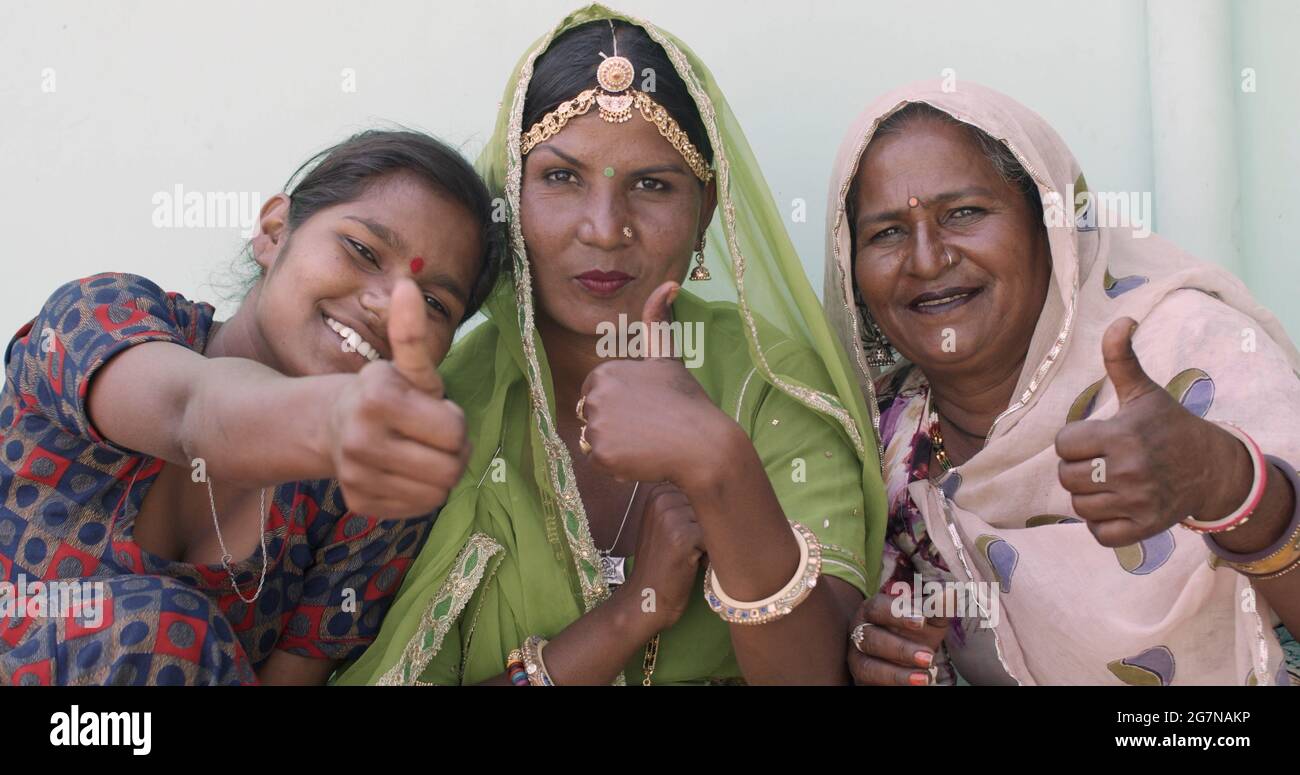 Group of indian females showing thumbs up outdoors Stock Photo - Alamy