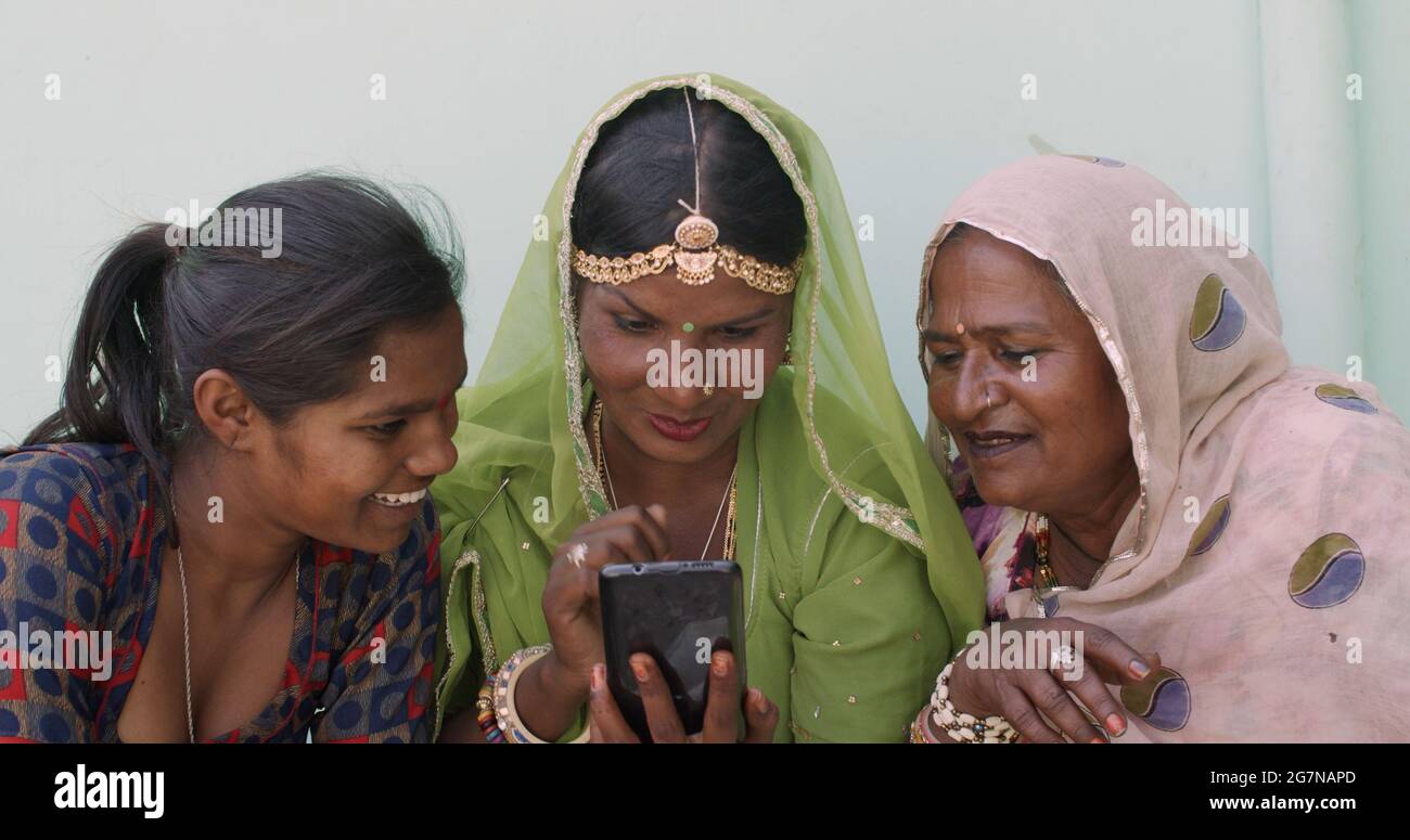 Group of indian females talking via smartphone outdoors Stock Photo - Alamy