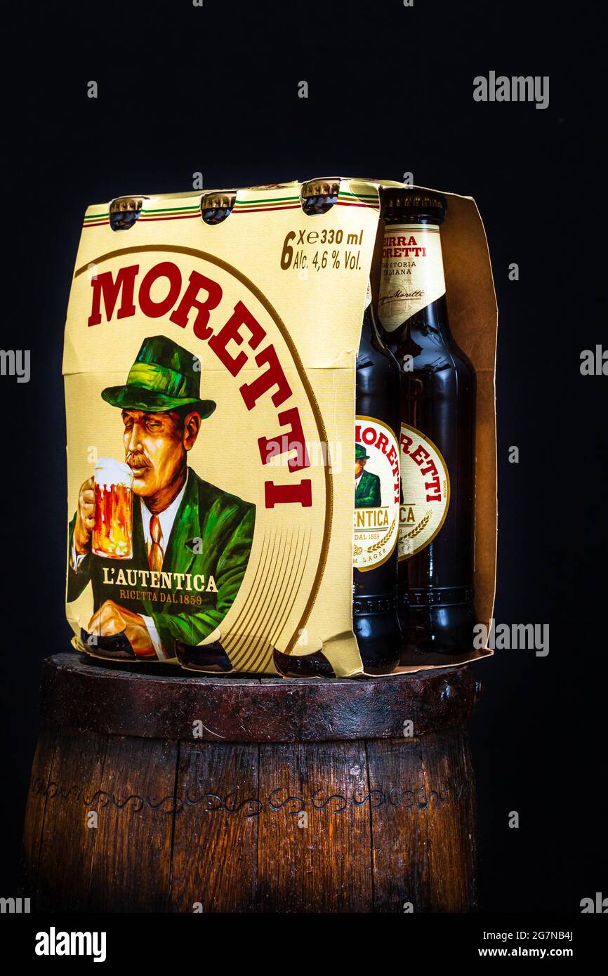 6 pack of Birra Moretti beer on wooden barrel with dark background ...