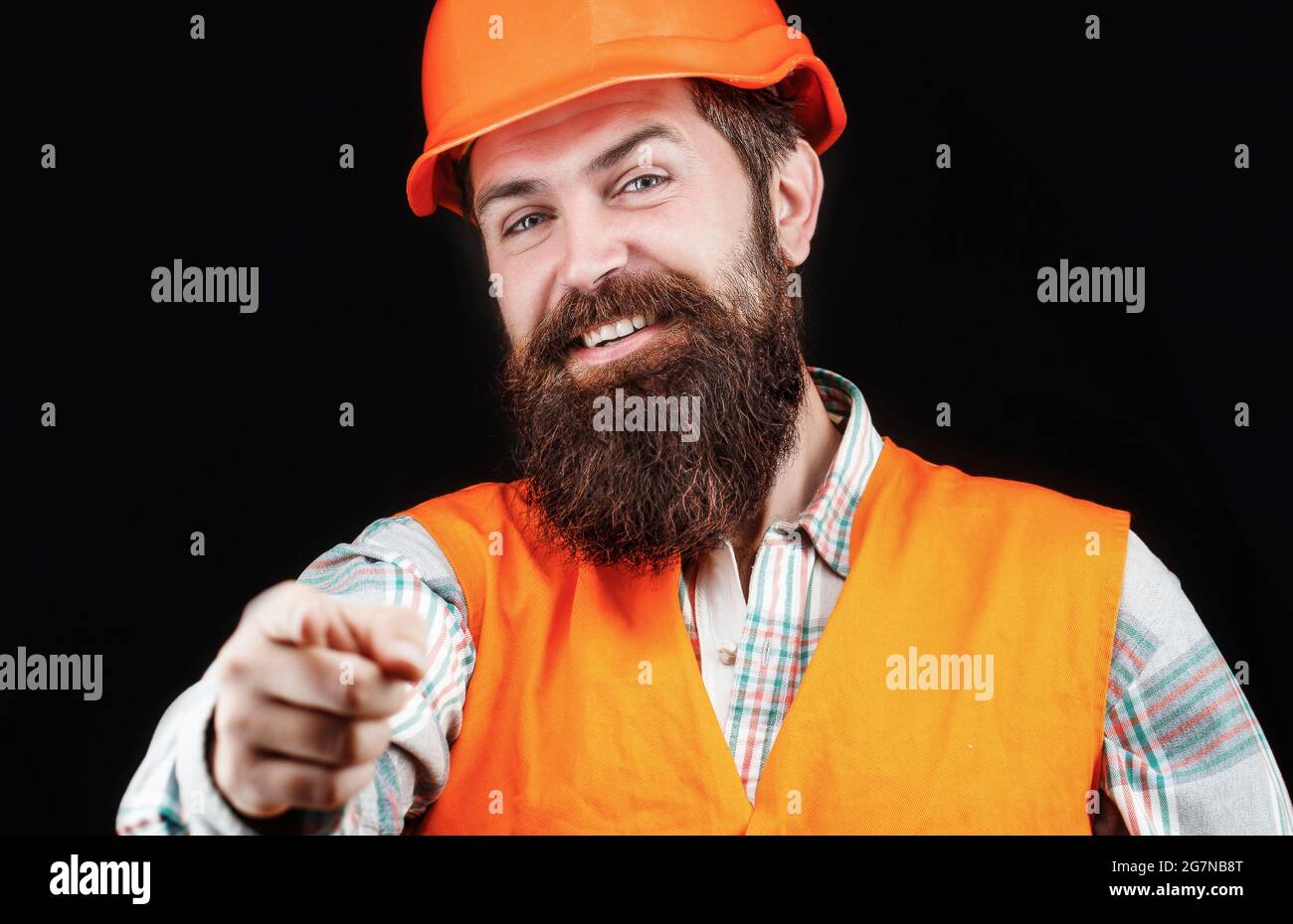 Portrait of a builder smiling. Bearded man worker with beard in ...