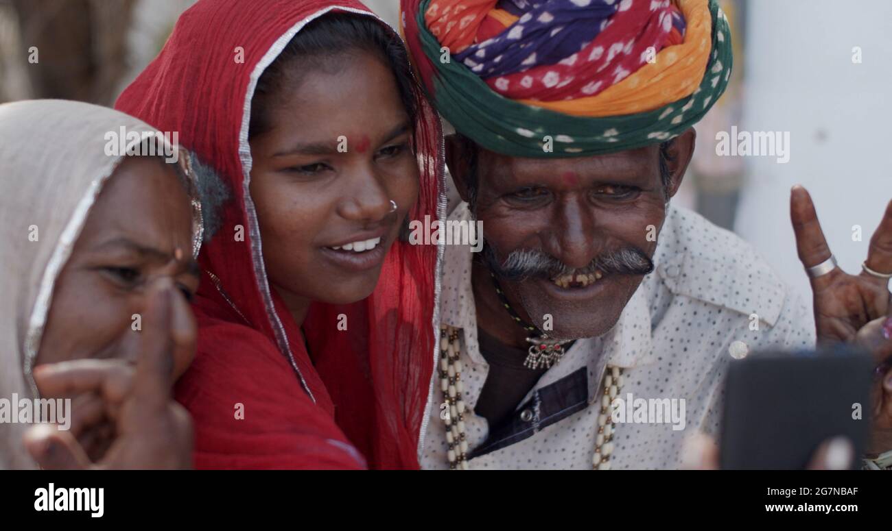 Group of South Asian people in traditional Indian clothing taking a ...