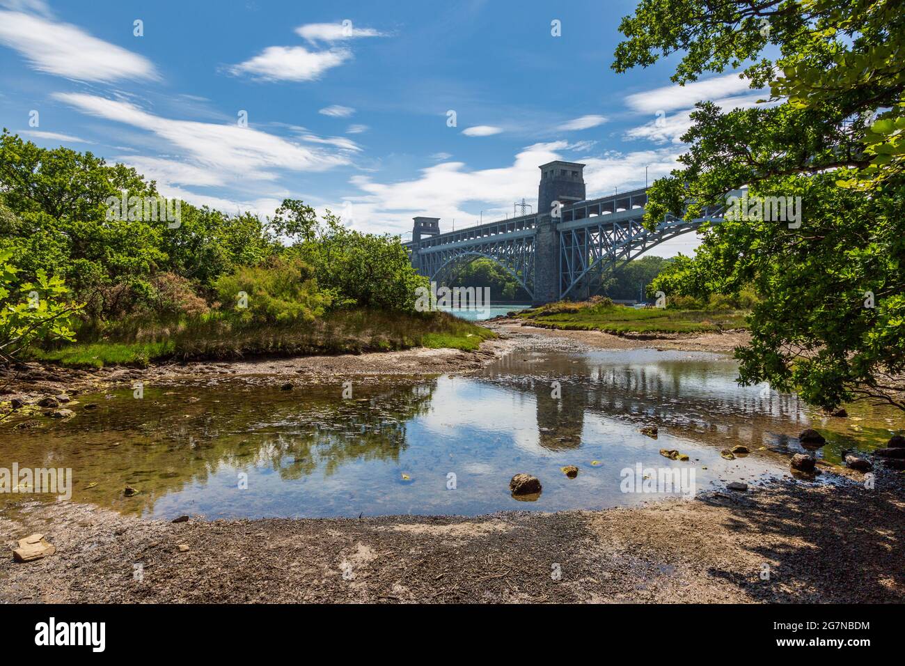 The Britannia Bridge from the shoreline of the Menai Strait at low-tide ...