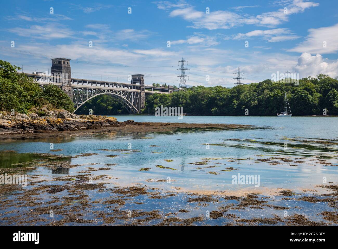 The Britannia Bridge from the shoreline of the Menai Strait at low-tide ...