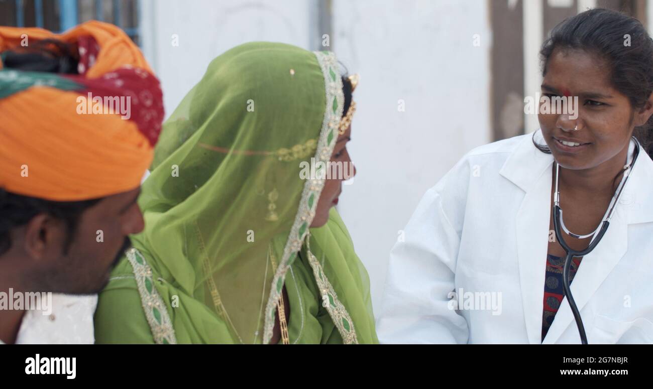 Woman doctor from India visiting an Indian family in traditional ...