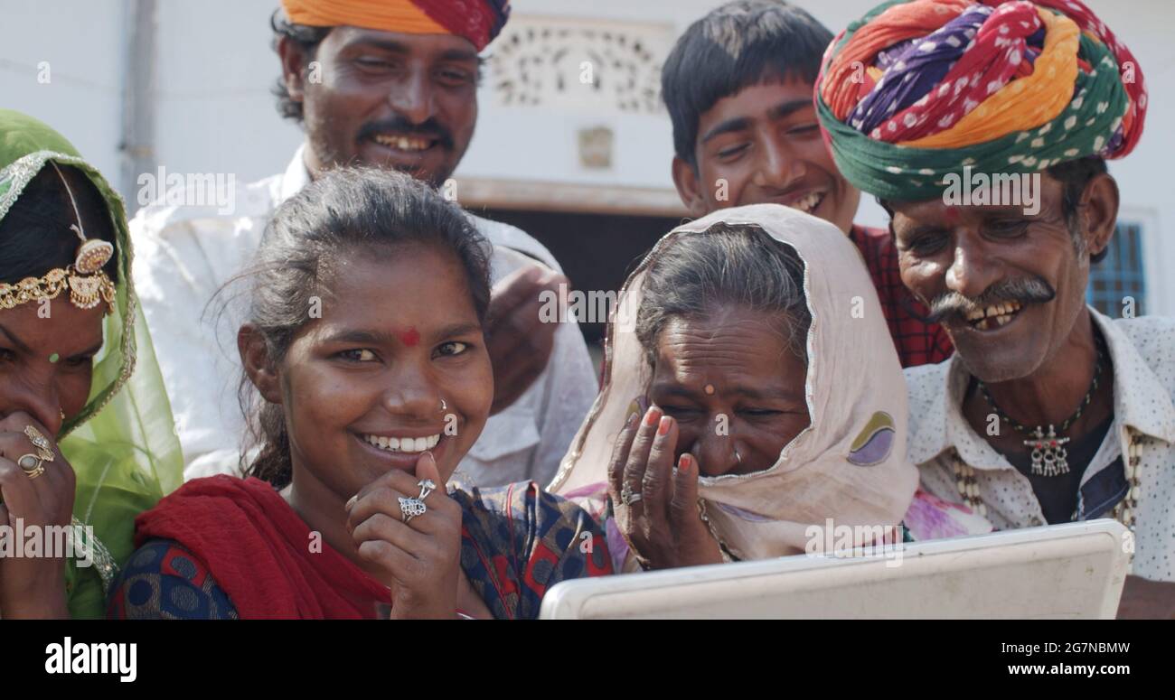 Beautiful family from India in traditional costumes video chatting with ...