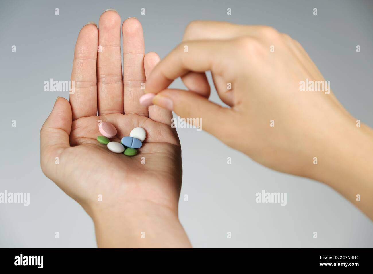 ills,green pill box and young woman hand in white background. Hand ...