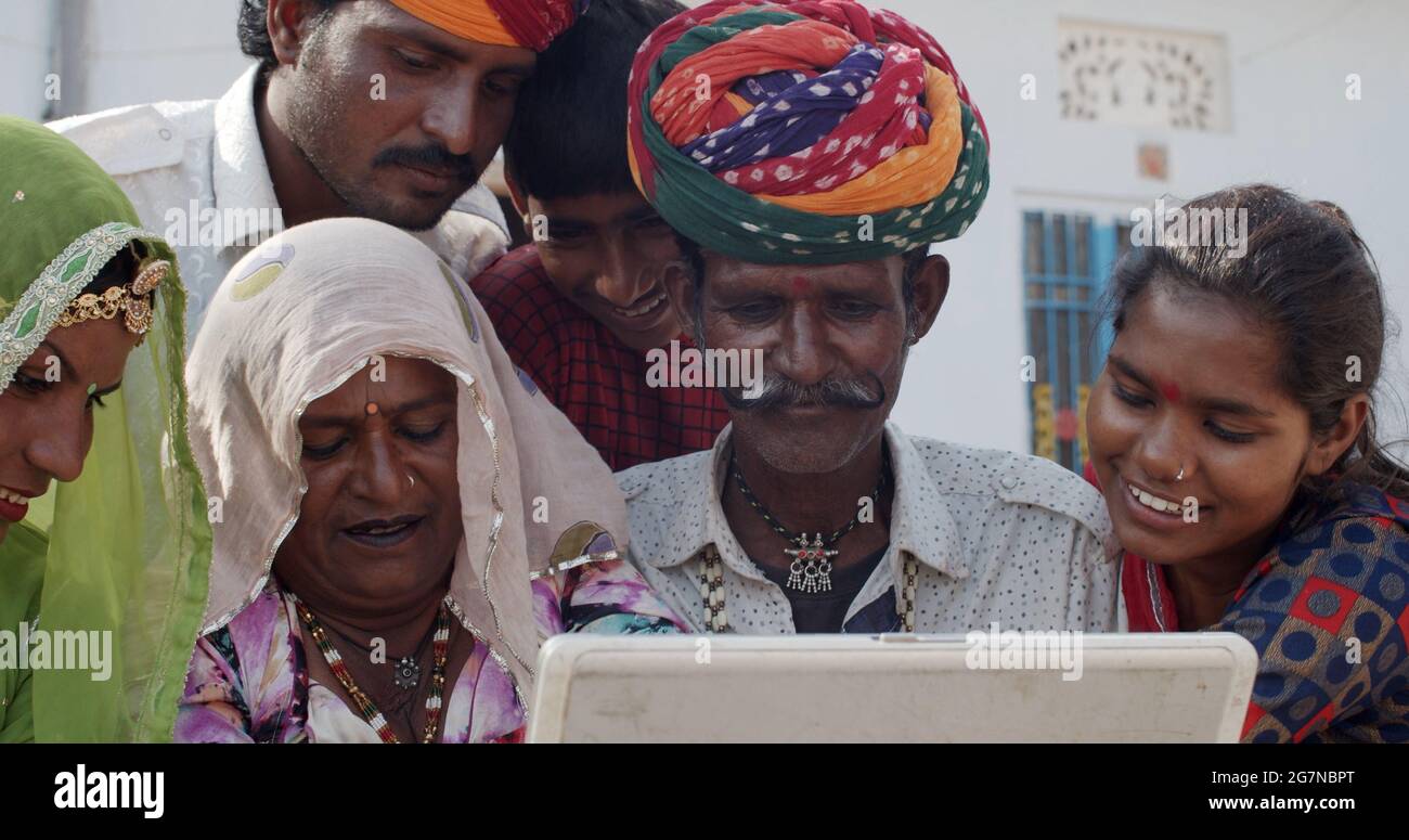 Group of indian people looking at a device Stock Photo - Alamy