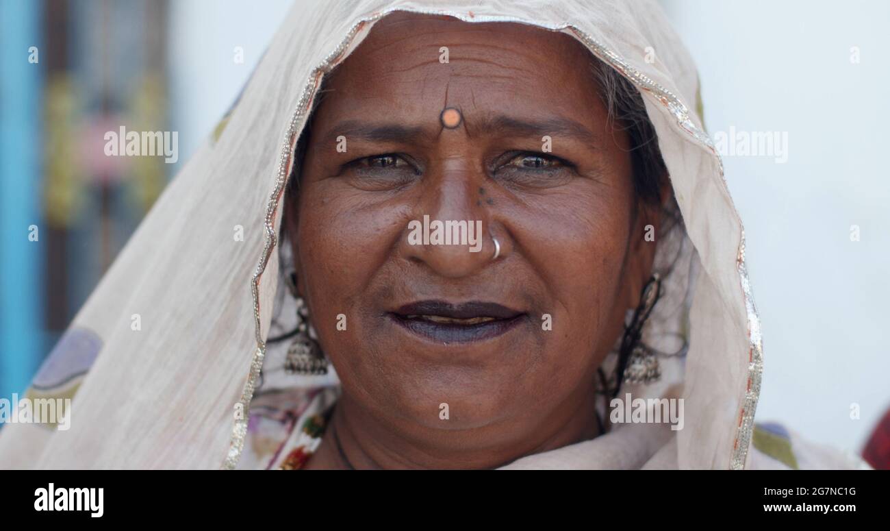 Portrait of a beautiful old woman from India in a traditional costume ...