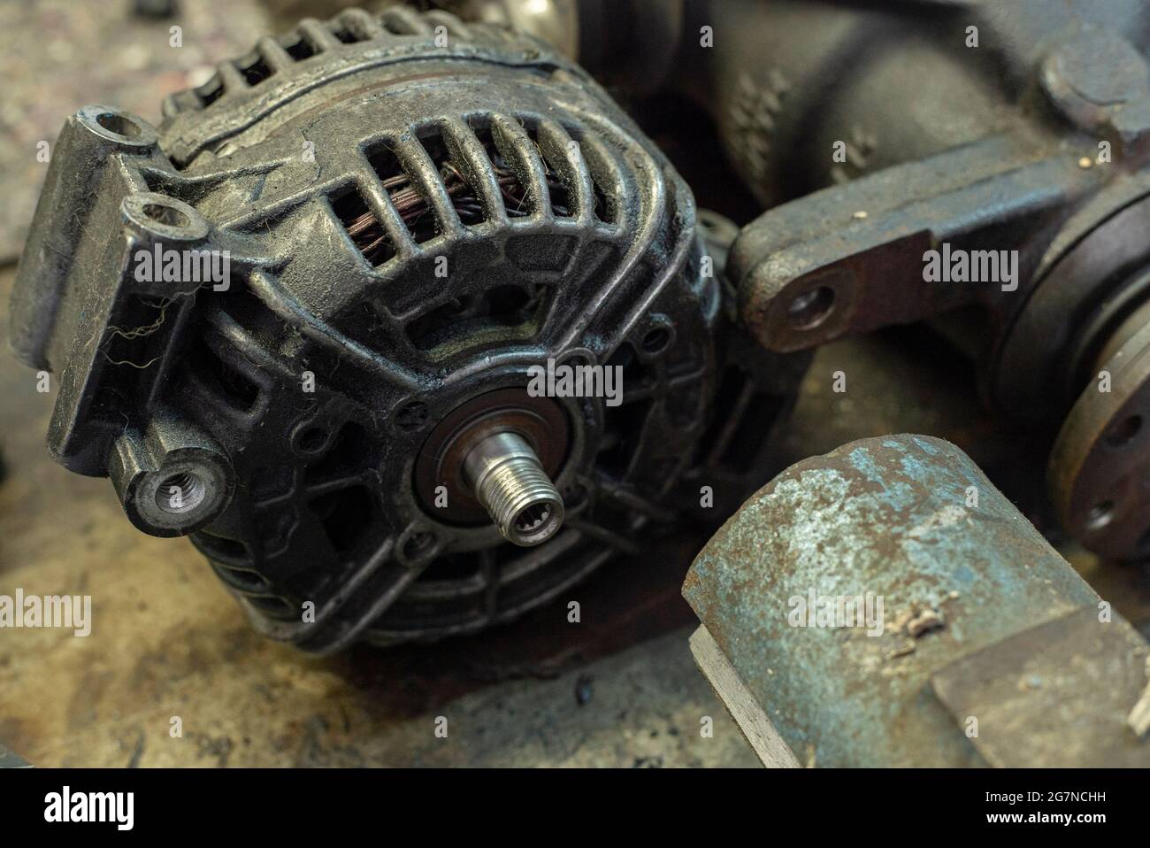 Old car alternator detail in a workshop bench Stock Photo - Alamy