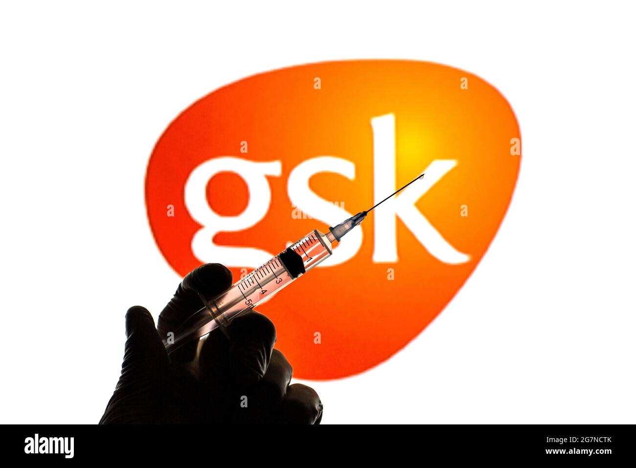 In this photo illustration a hand holding a medical syringe seen in ...