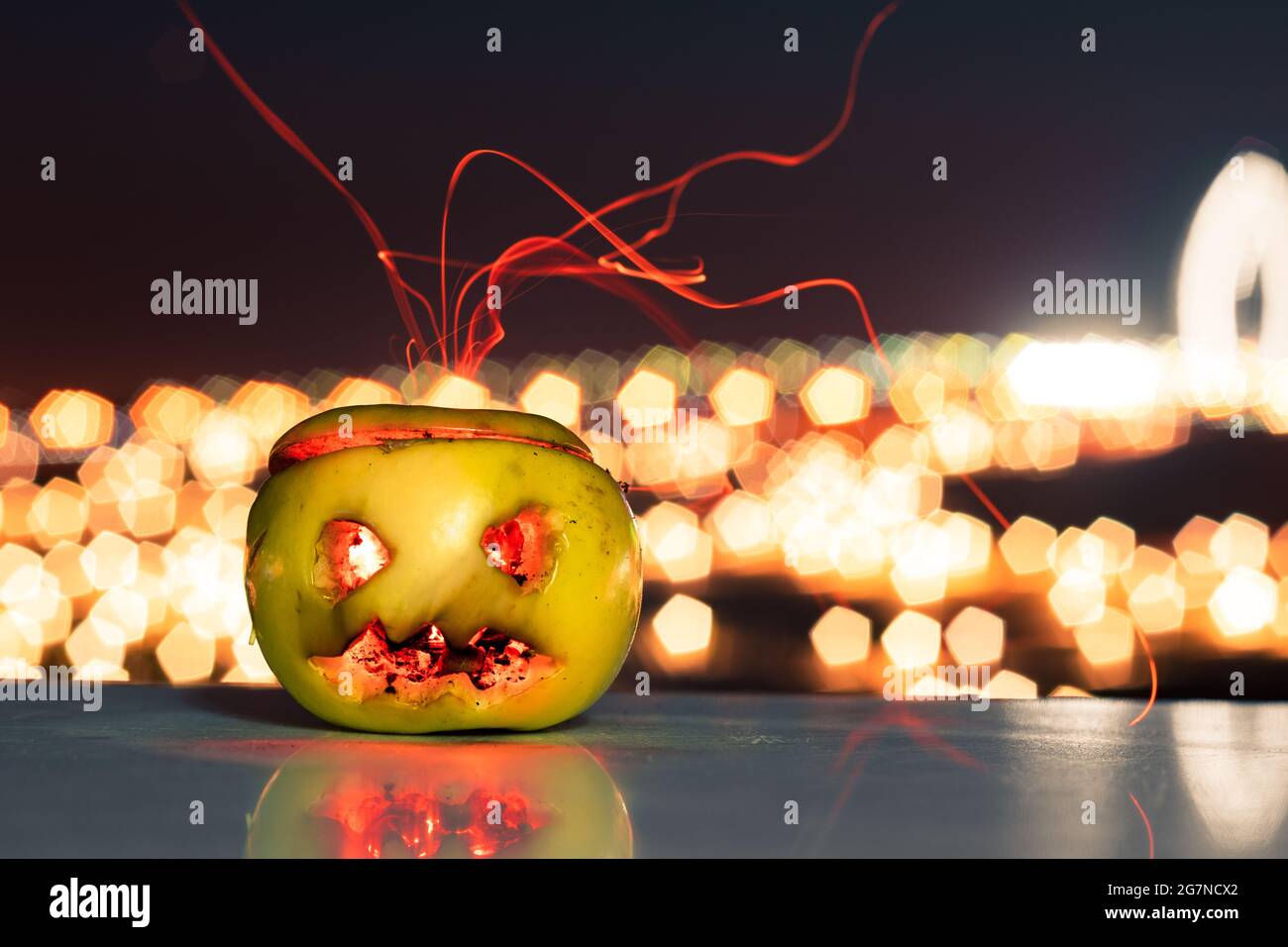 A Halloween Evil jack o lantern apple on a background of a night city ...