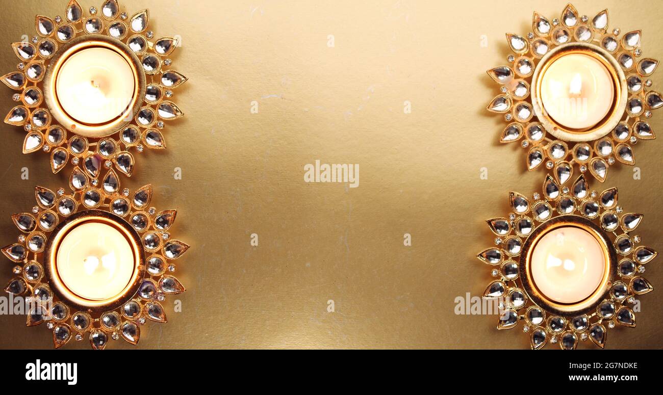 Top view of burning decorative Diwali candles on a golden surface Stock ...