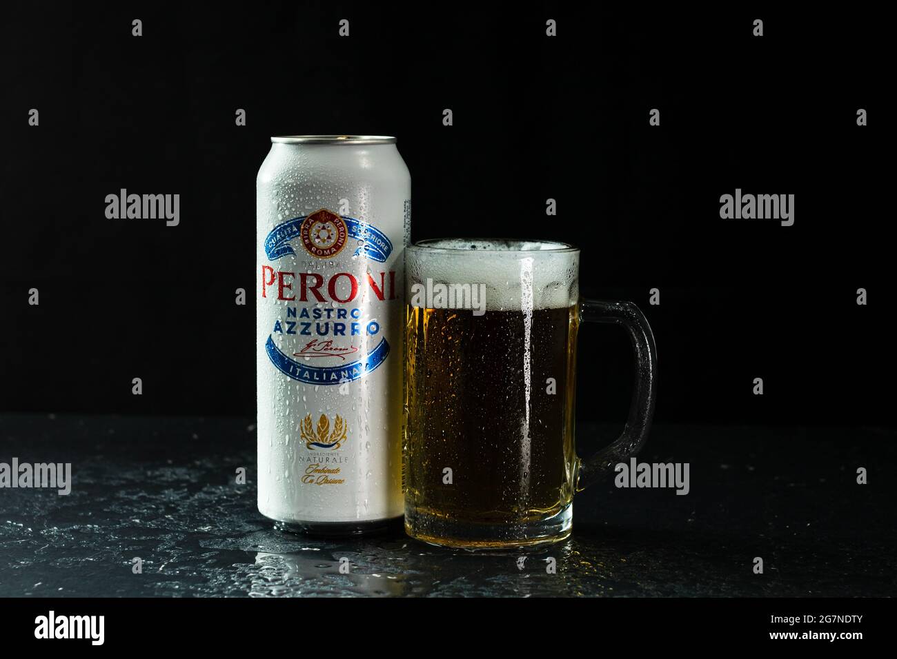 Can of Peroni Nastro Azzurro beer and beer glass on dark background ...