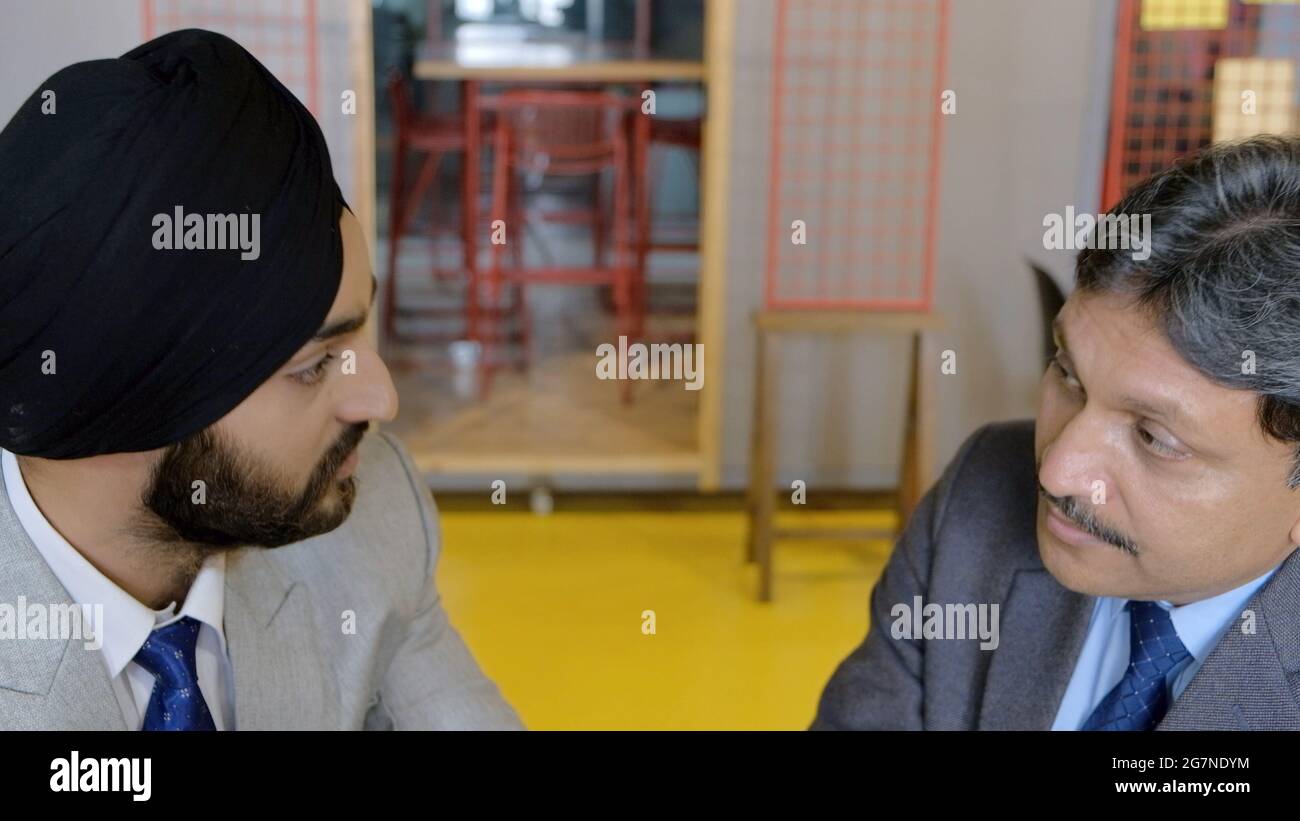 Shallow focus of a two Indian men communicating Stock Photo - Alamy