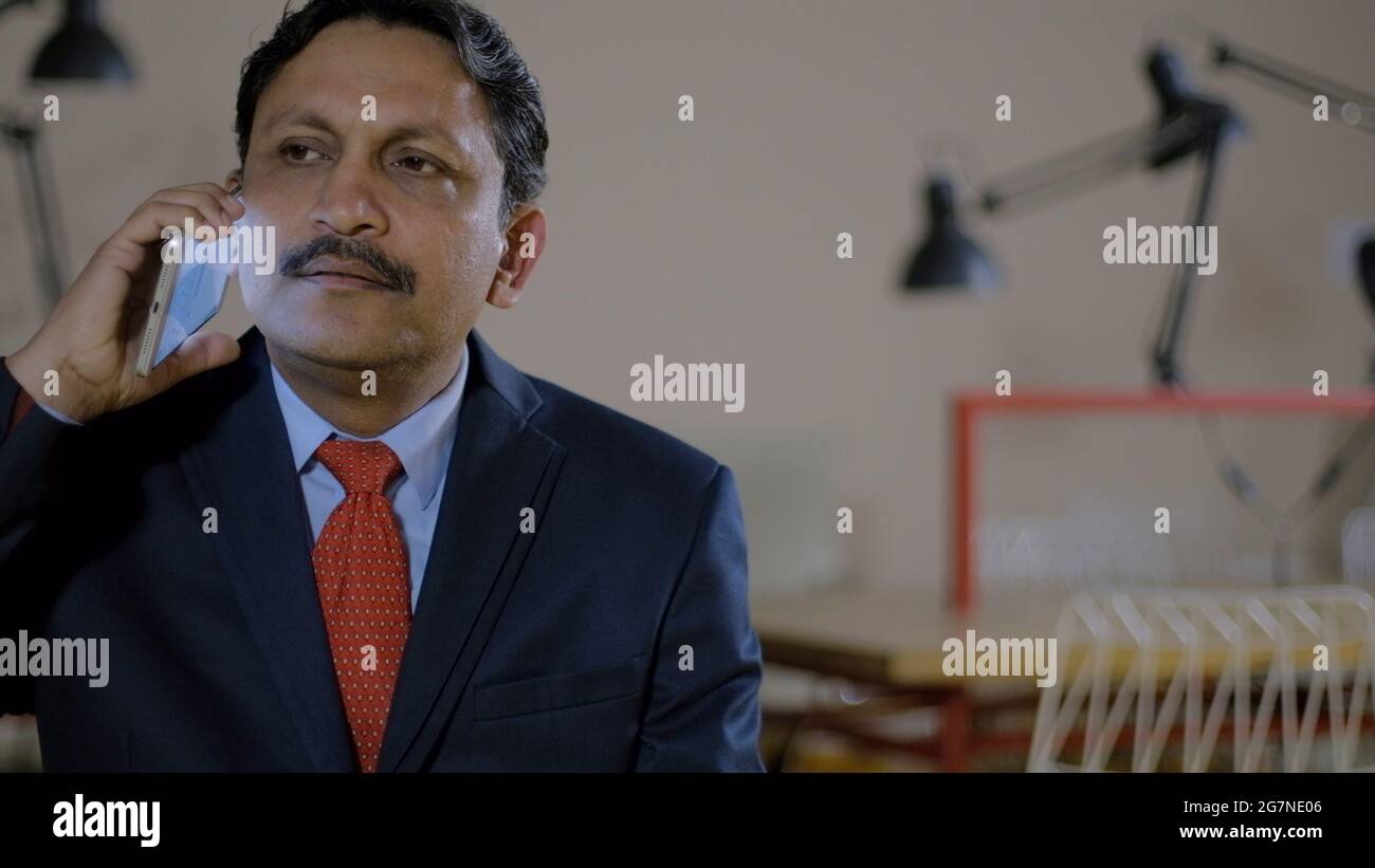 Shallow focus of an Indian man making a phonecall in the office Stock ...