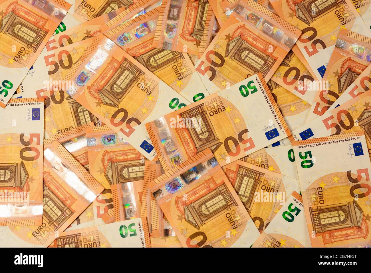 Pile of 50 real euro banknotes isolated on a black background. new ...
