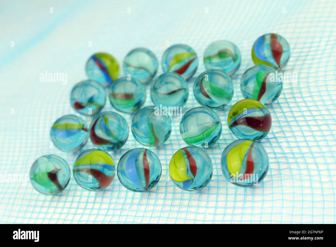 Marbles of Glass Group, Fishing Net Plastic Stock Photo - Alamy