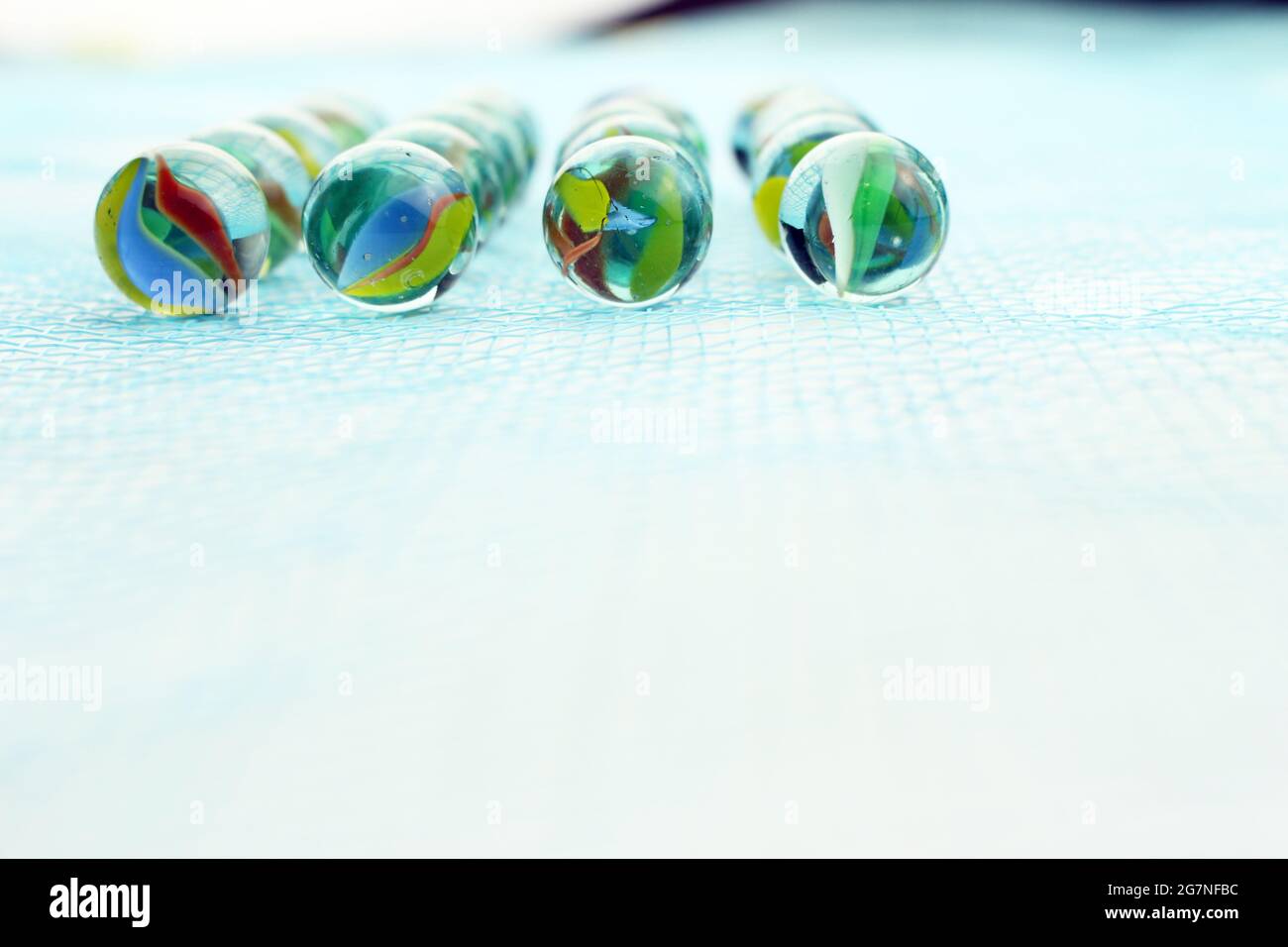 Marbles of Glass Group, Fishing Net Plastic Stock Photo - Alamy