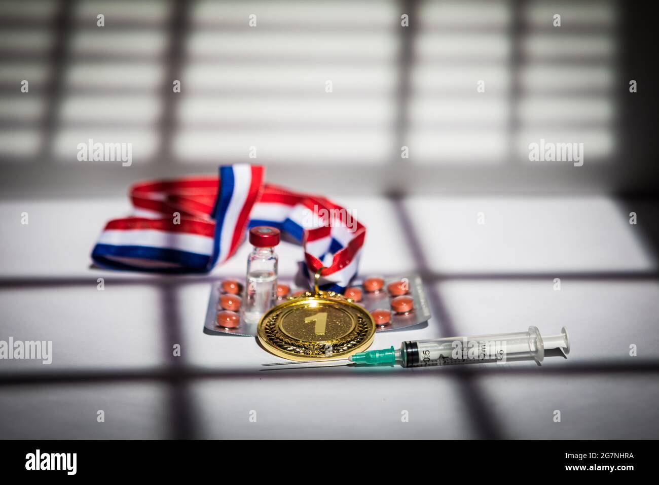 Champion gold medal, doping substance syringe, pill tablet and prohibited substance vial with ...