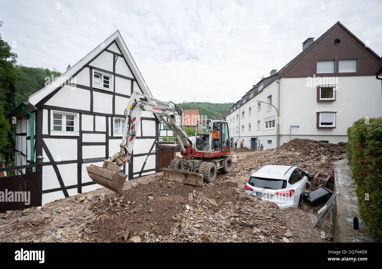 Hagen, Germany. 15th July, 2021. Helpers clear debris from a road in ...
