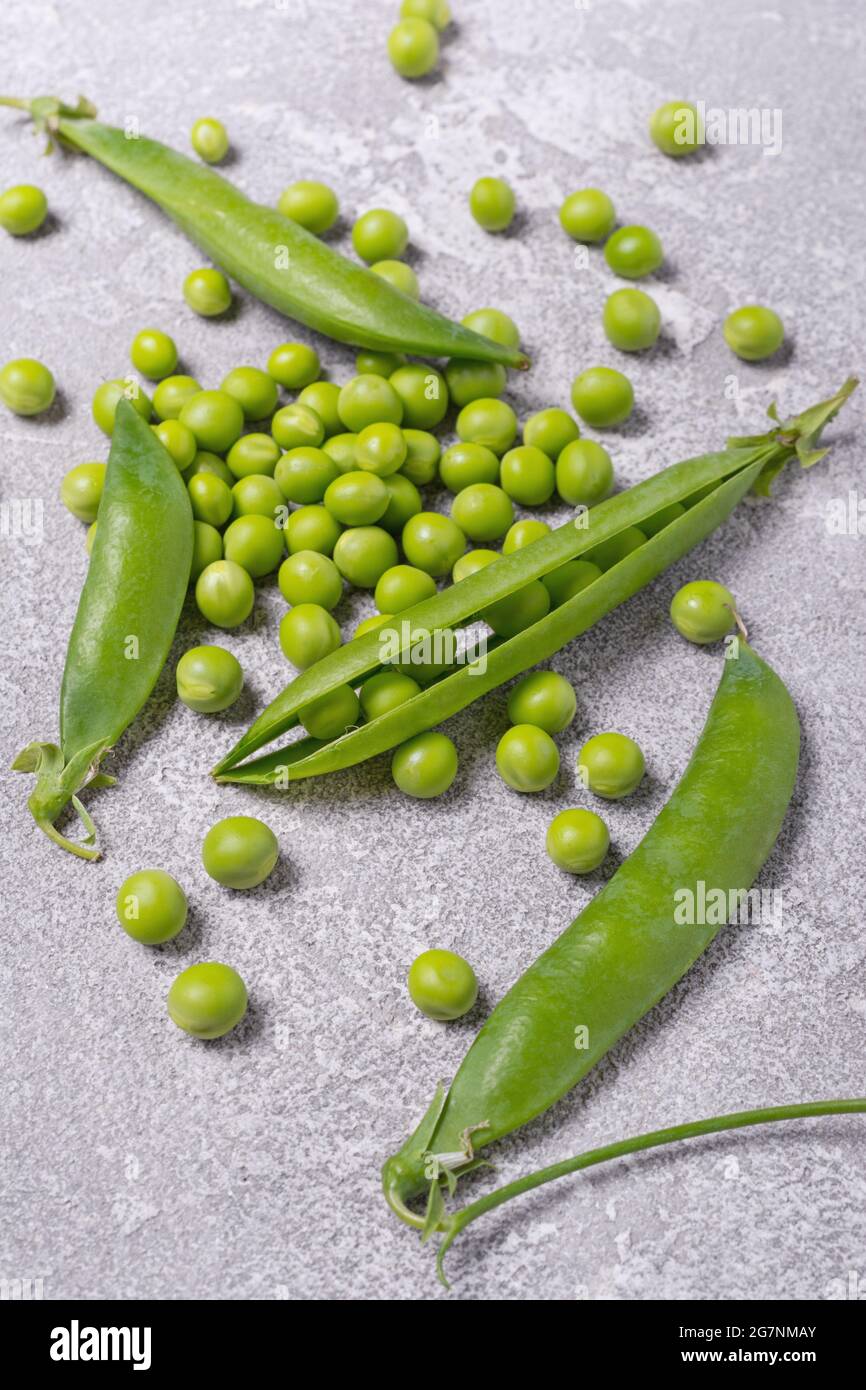 Fresh green peas for healthy nutrition on grey concrete background ...