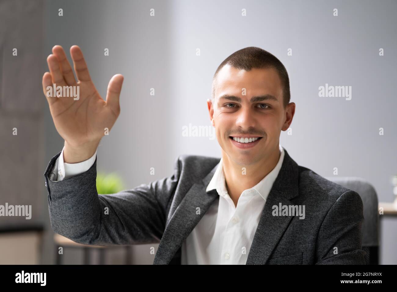 Man Portrait Waving Hello In Video Conference Stock Photo - Alamy