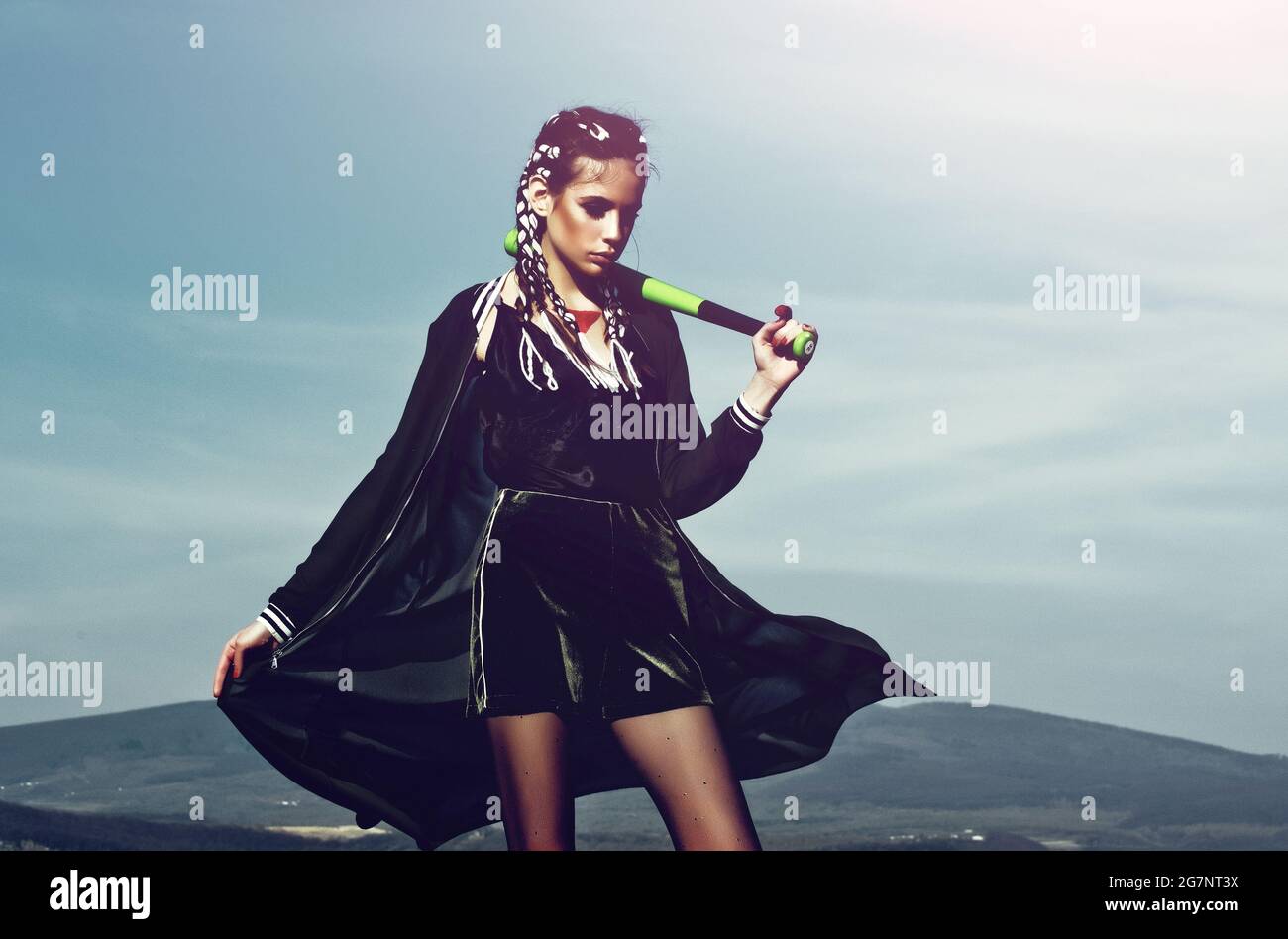 Pretty woman with braids posing with baseball bat in hand Stock Photo ...