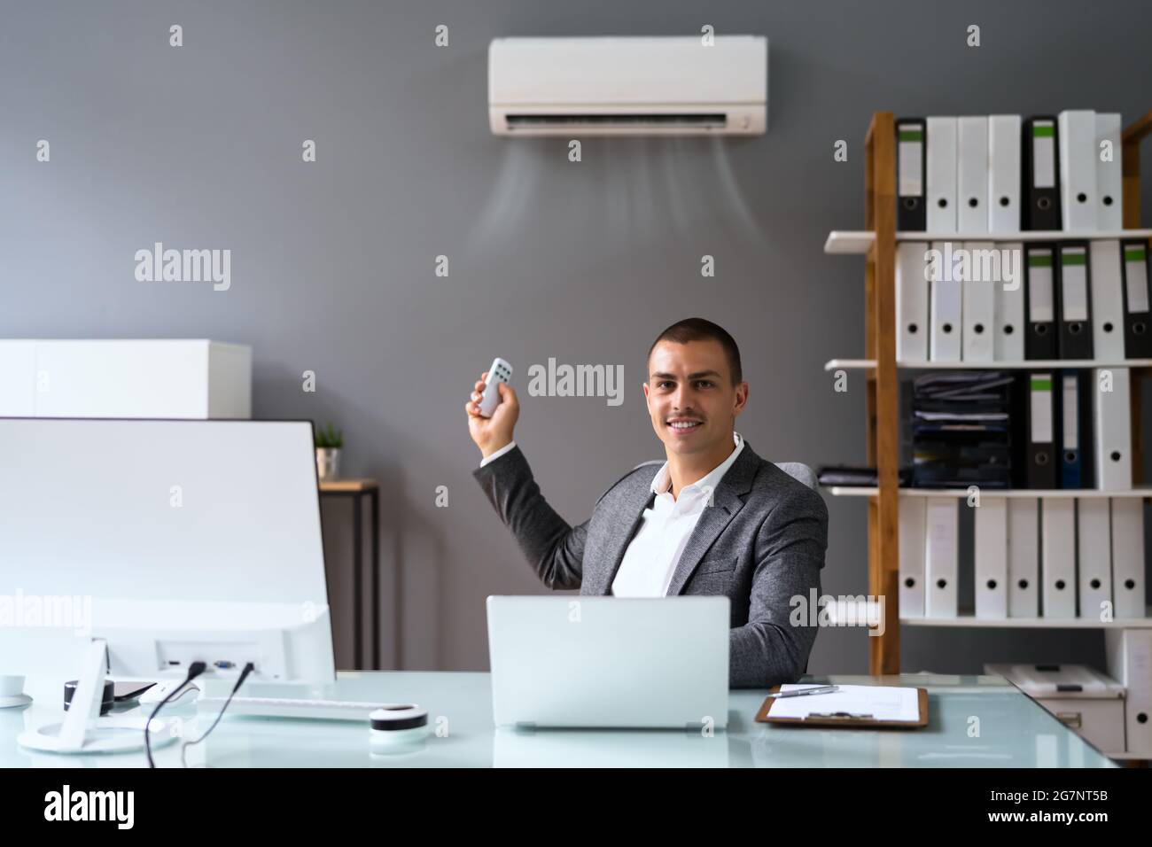 Businessman Working In Office With Air Conditioning Stock Photo - Alamy