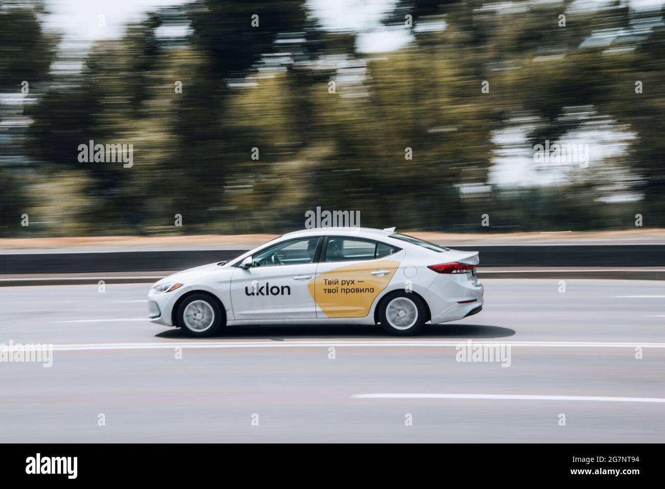 Ukraine, Kyiv - 27 June 2021: White Hyundai Elantra Taxi Uklon car ...
