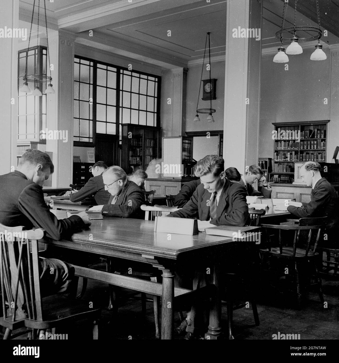 1950s, historical, people wroking at wooden tables in a public library ...