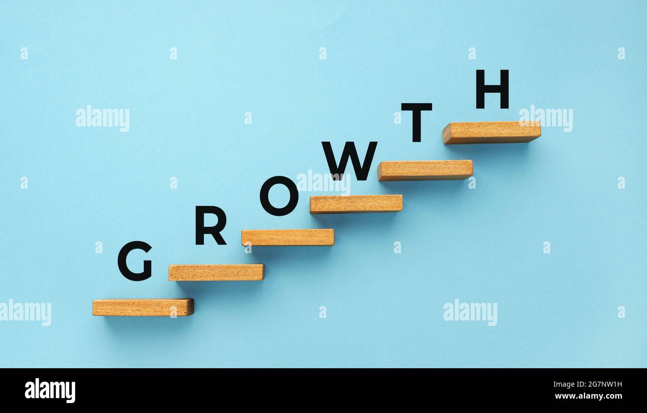Growth word on staircase on blue background. Increasing business ...