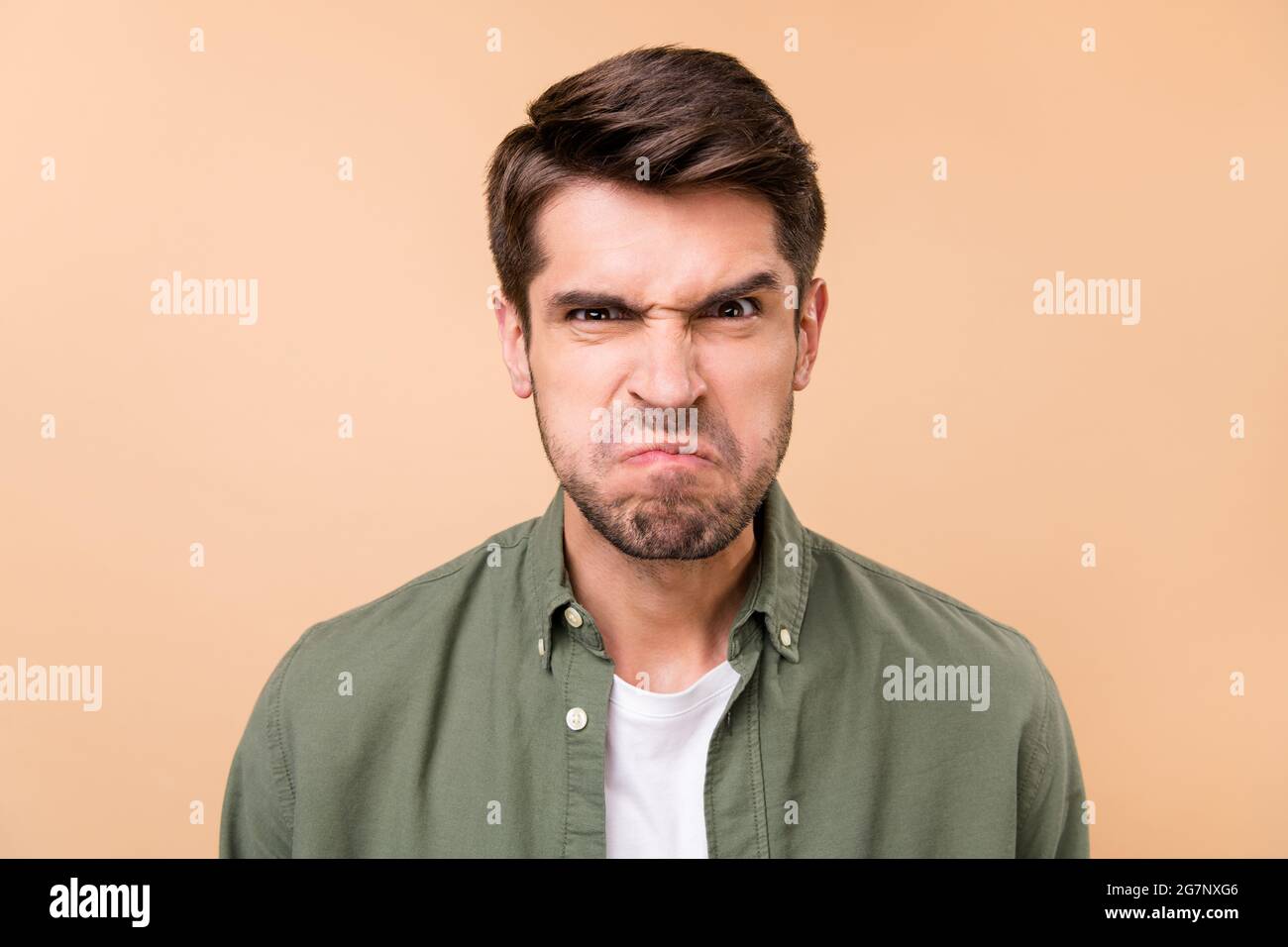 Photo of unhappy aggressive young man grimace face bad mood dislike ...