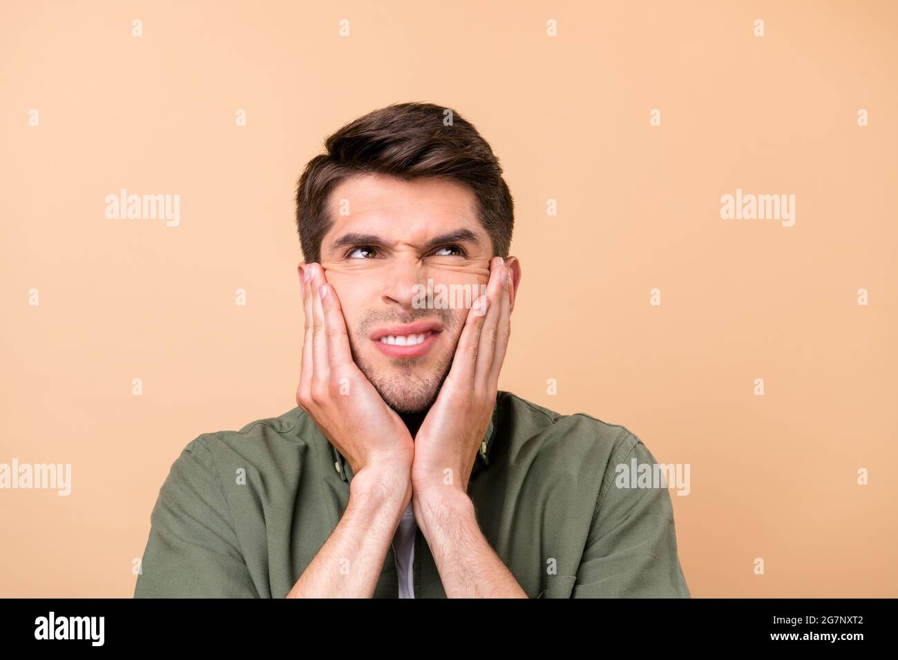 Photo of young unhappy sad stressed man look empty space hold hands ...