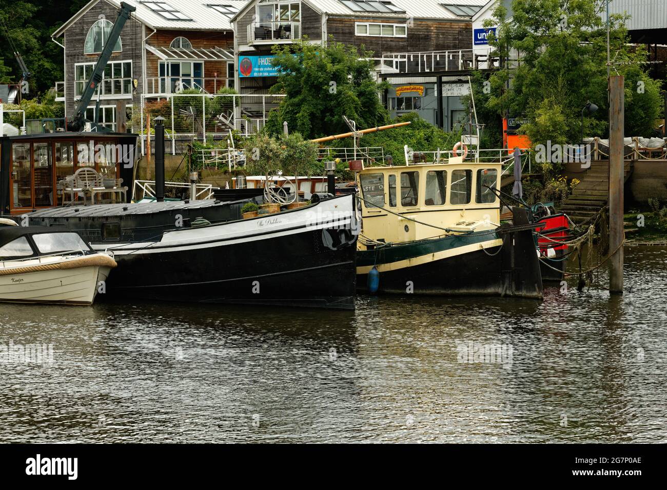 Boats moored on the River Thames by the Eel Pie Island shipyard and ...