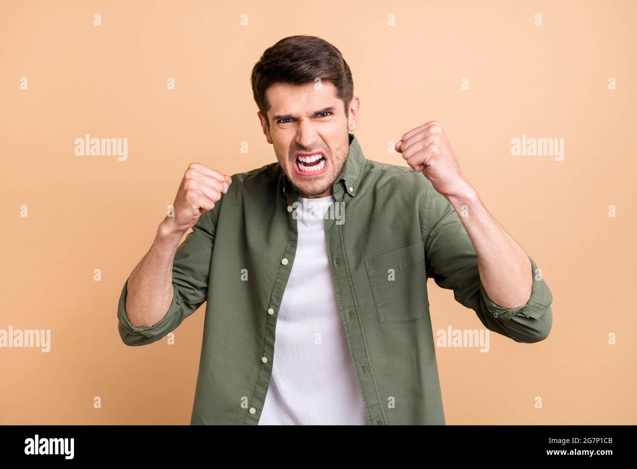 Photo of furious young angry man raise fists fighter argument bad mood ...