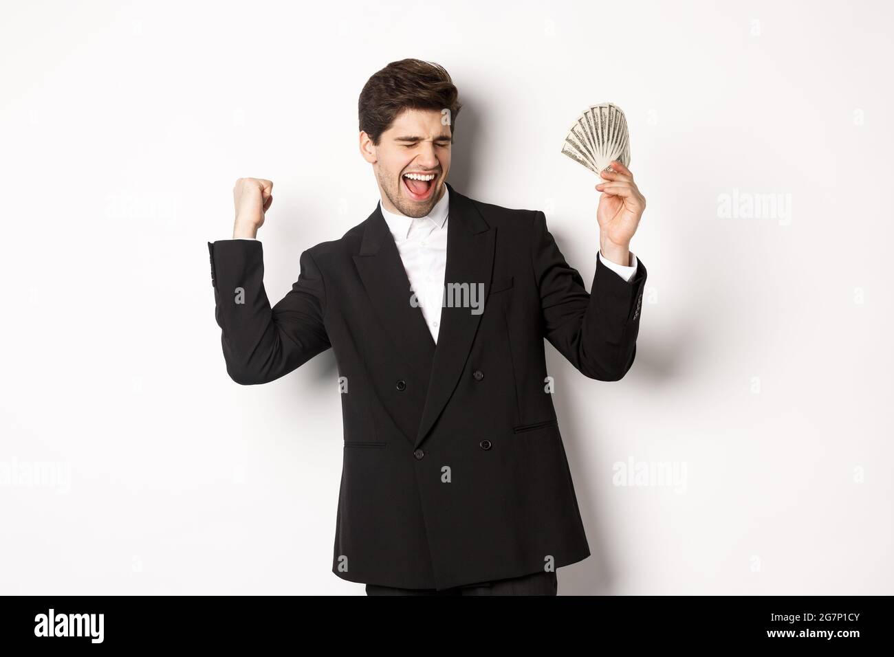 Portrait of handsome and successful businessman in suit, dancing with ...