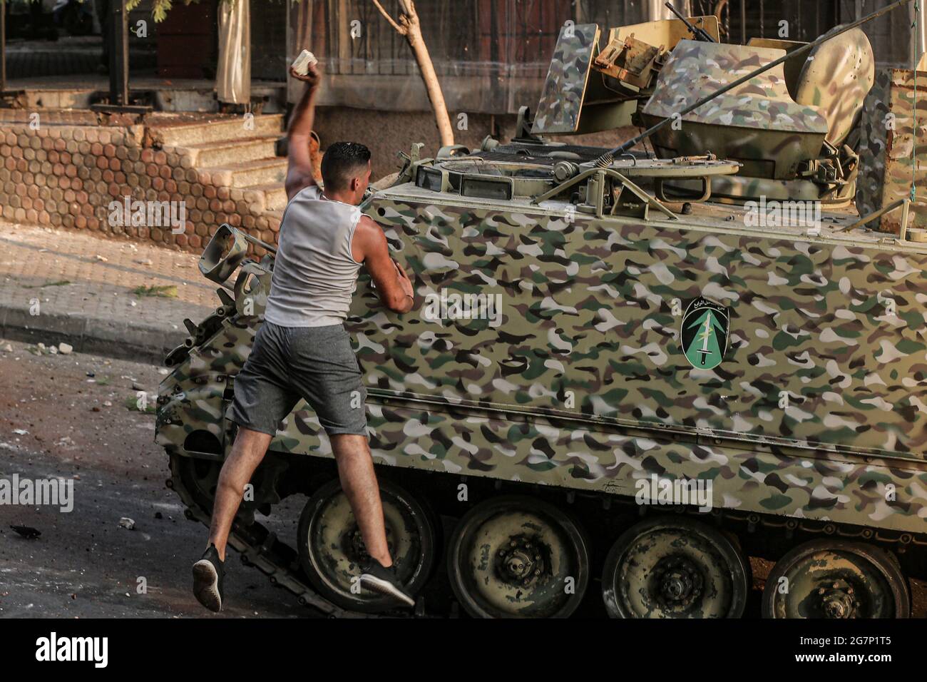 Beirut, Lebanon. 15th July, 2021. A protestor hurls rocks at Lebanese ...