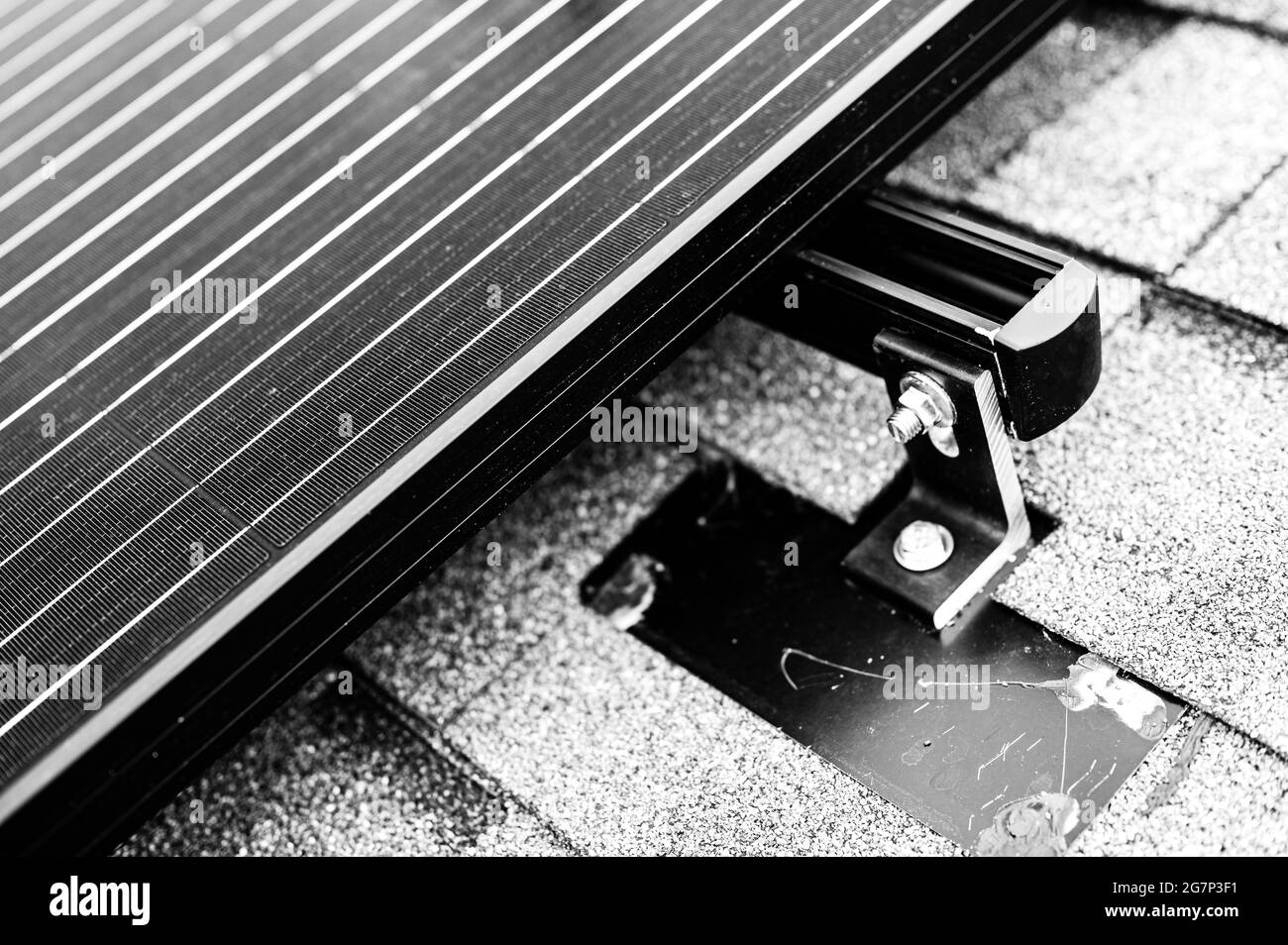 Rail, bracket, and anchor to a solar panel installed on a asphalt ...