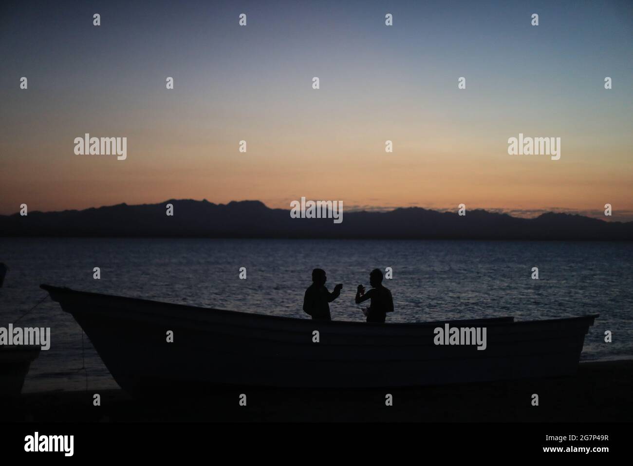 HERMOSILLO, MEXICO - JUNE 28: Two people toast at sunset next to a ...
