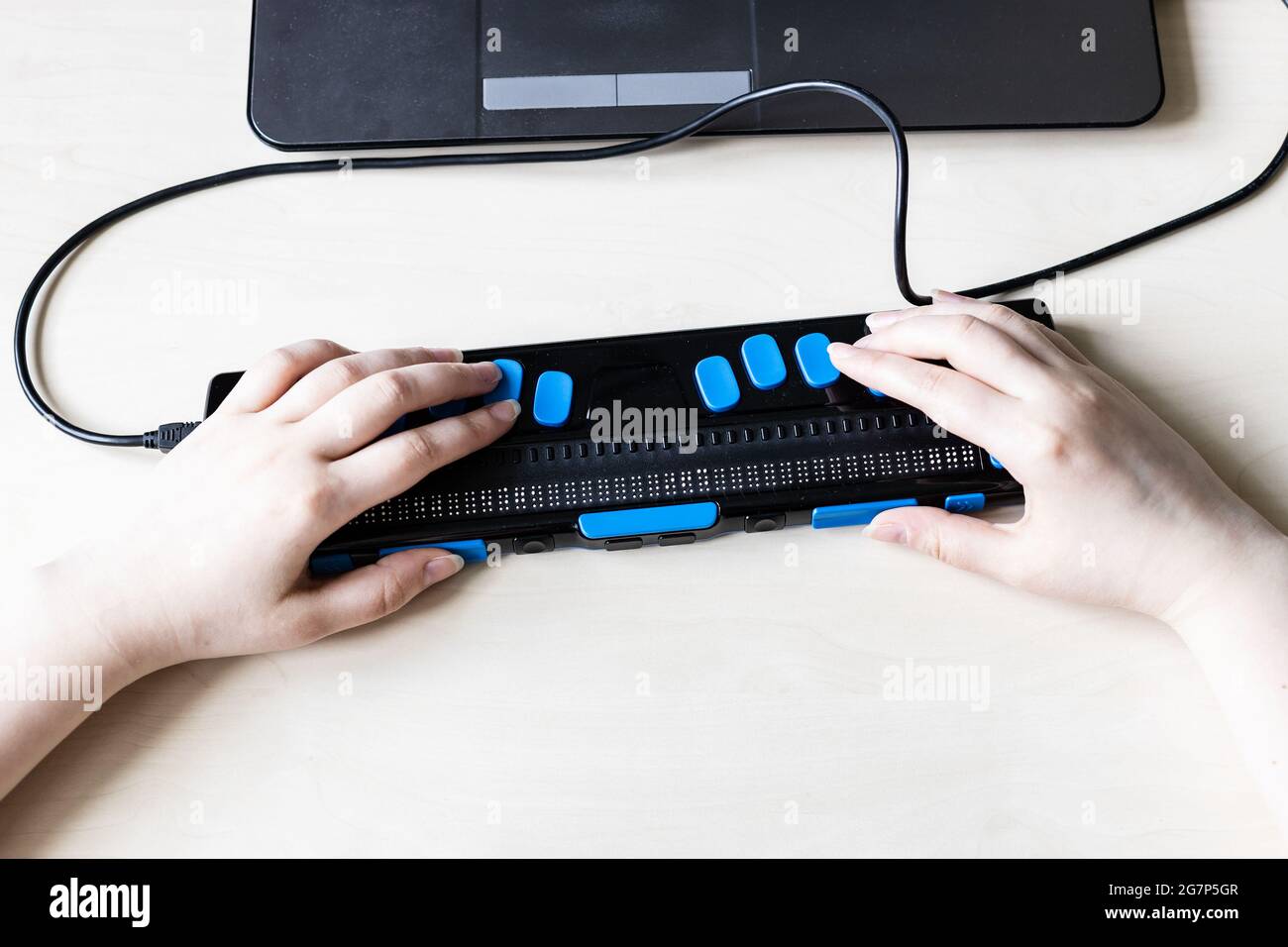 Moscow, Russia - June 5, 2021: hands on keys of Focus 40 Blue Braille ...