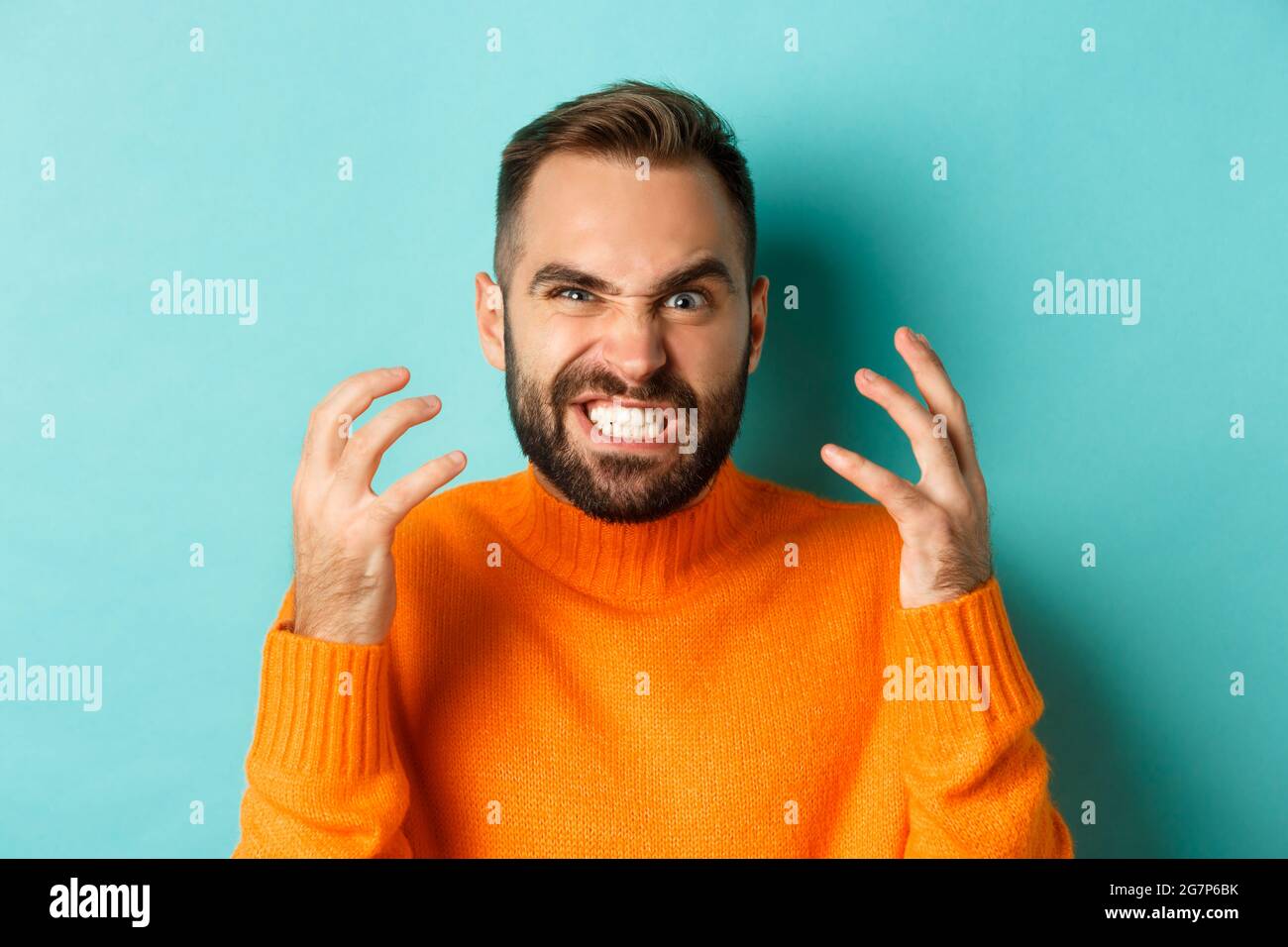 Close-up of angry caucasian man looking mad, grimacing and shaking ...