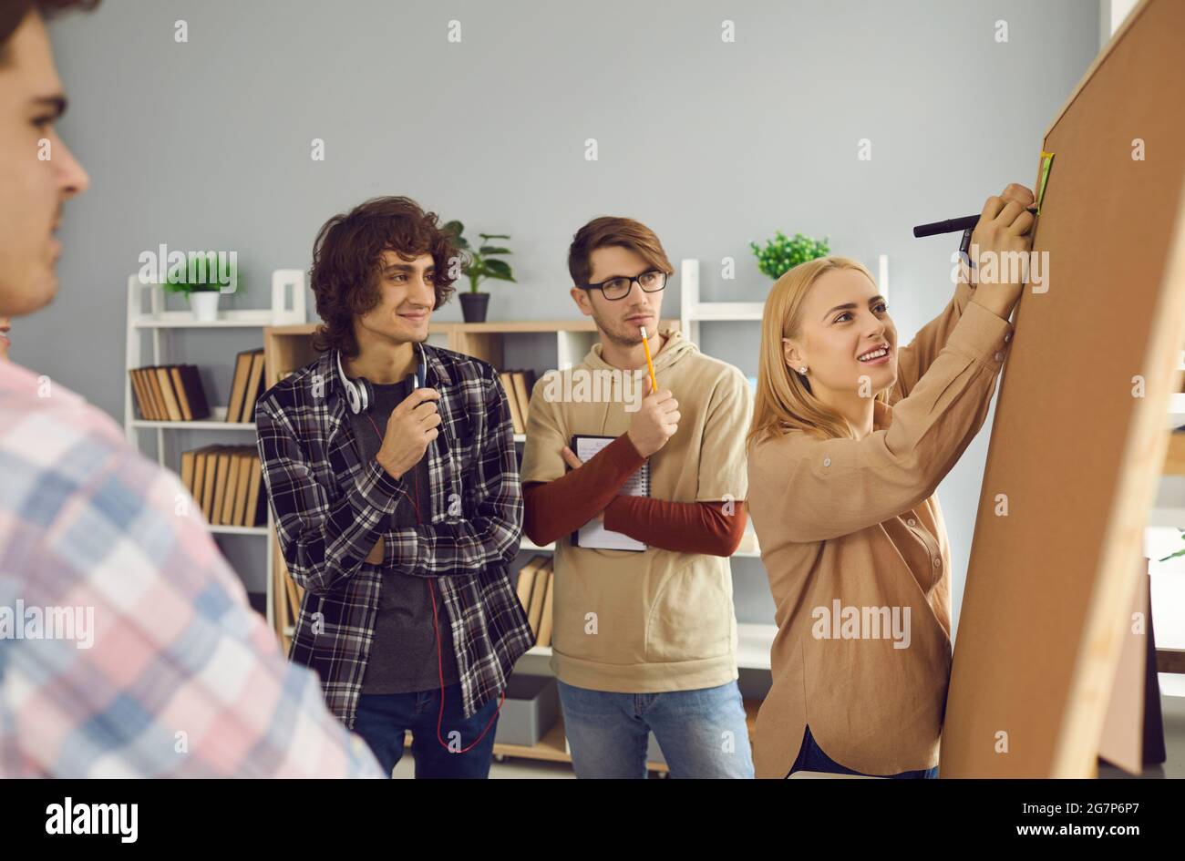 Teenager college student schoolmates brainstorming standing together at ...